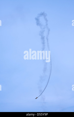 acrobatic airplane doing acrobatics with the smoke on the sky Stock ...