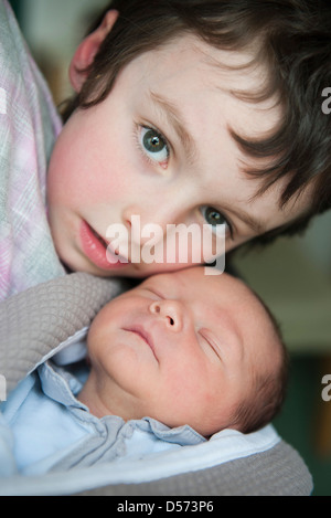 Portrait of newborn baby and his brother in Santa clothes, sleeping in ...