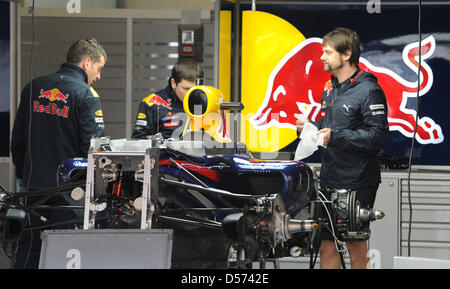 Red Bull mechanics work on the car of driver Max Verstappen of the ...