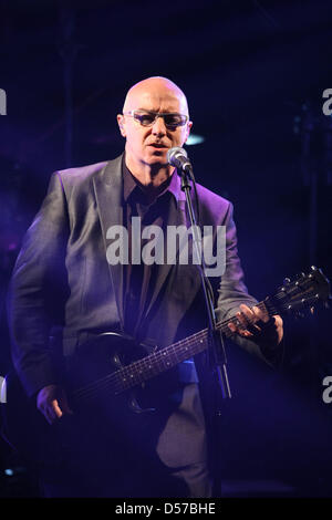 Midge Ure singer in Ultravox poses beside his Harley Davidson ...