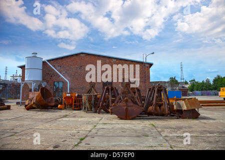 Excavator's work tool old rusty bucket, alfresco improvised warehouse ...
