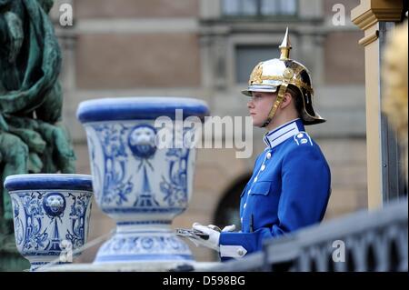 A female guard is on duty at one of the gates of the Royal Palace in ...