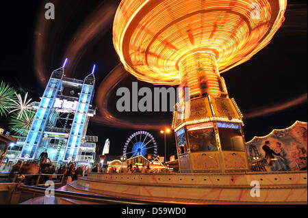 Visitors ride the carousel chair swing ride during the Wisconsin State ...