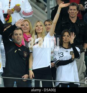 Daniela Loew (C), the wife of German headcoach Joachim Loew, and Silvia ...