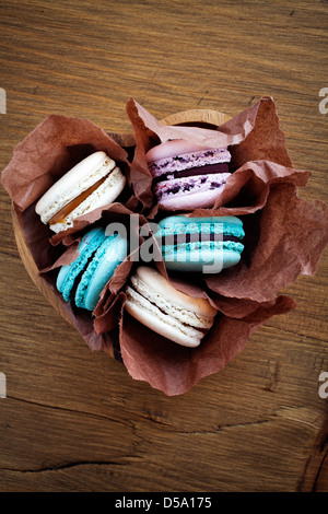 Colorful sweet macarons or macaroons, cherry flavored cookies on pink ...