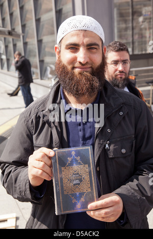 Berlin, Germany, shows man the Koran, in the background, police Stock ...