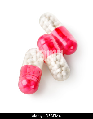 Three red capsules Stock Photo - Alamy