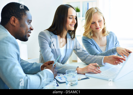 Team of three considering optimal business solution Stock Photo - Alamy