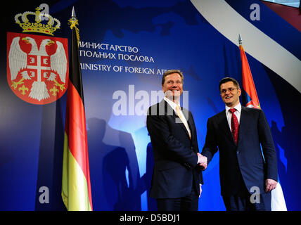 Serbian Foreign Minister Vuk Jeremic, left, shakes hands with his ...