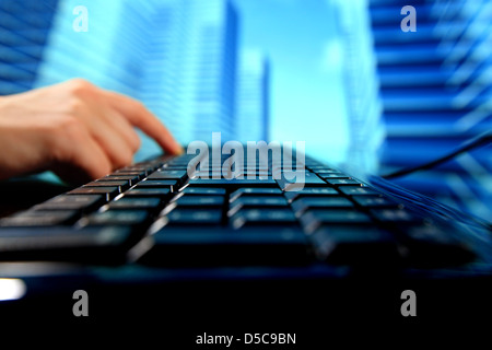 reseller work on keyboard skyscrapers on background Stock Photo - Alamy