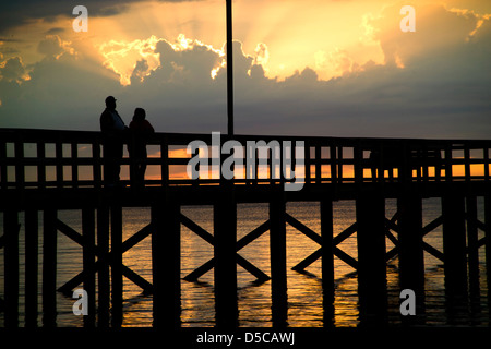 Two people watching sunset Stock Photo - Alamy