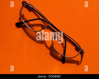 male wire-rim glasses isolated on an orange background Stock Photo - Alamy