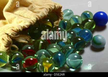 Marbles spilling out of drawstring bag Stock Photo - Alamy