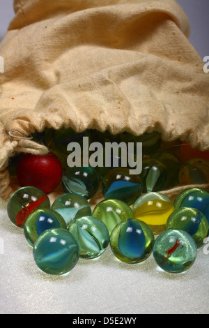 Marbles spilling out of drawstring bag Stock Photo - Alamy