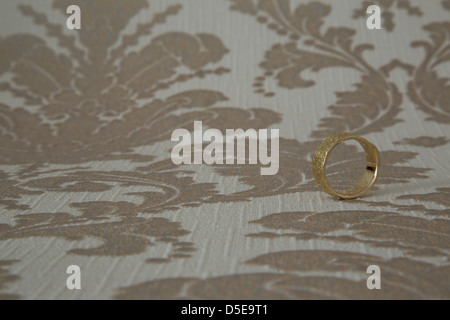 A golden wedding ring in front of a Wallpaper. March 2013 Stock Photo ...
