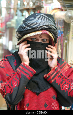 Portrait of young bedouin woman in traditional clothing with braided ...
