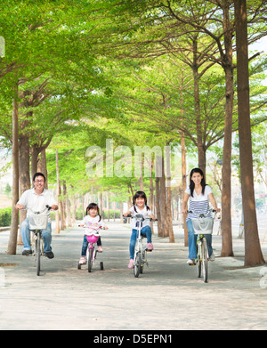 Cheerful young Chinese family riding horses Stock Photo - Alamy