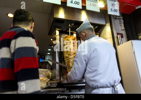 Turkish man prepares Doner Kebab at a street food stall Stock Photo - Alamy