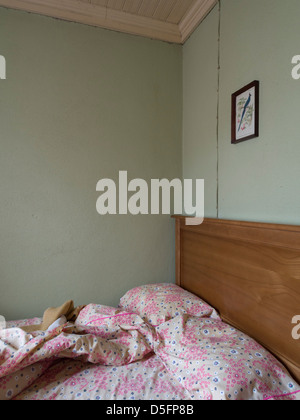 Unmade bed in a messy bedroom Stock Photo - Alamy