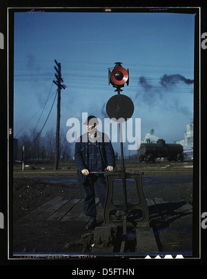 In this 1943 photograph, a switchman at Indiana Harbor Belt Railroad ...