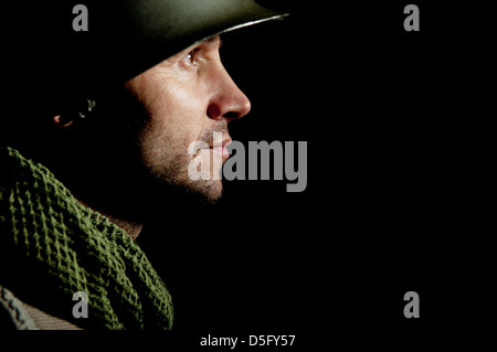 Portrait in profile of a WW2 U.S. soldier against a black background ...