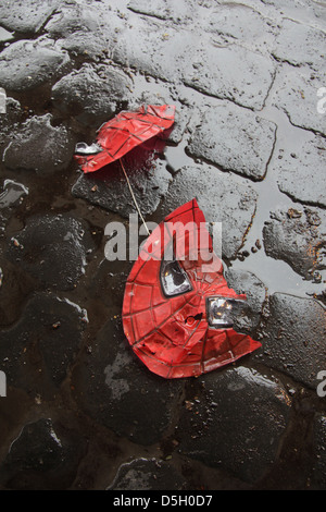 broken spiderman plastic mask on wet road in city town Stock Photo - Alamy
