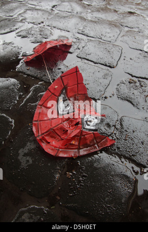 broken spiderman plastic mask on wet road in city town Stock Photo - Alamy