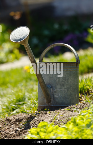 Old rusty garden sprinkler with a green plant background Stock Photo ...