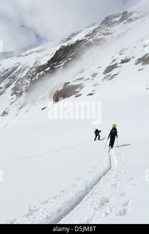Two mountaineers on a hiking trail, view of a blue mountain lake, Lac ...