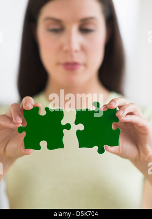 female hand with green puzzle piece isolated on white background Stock ...