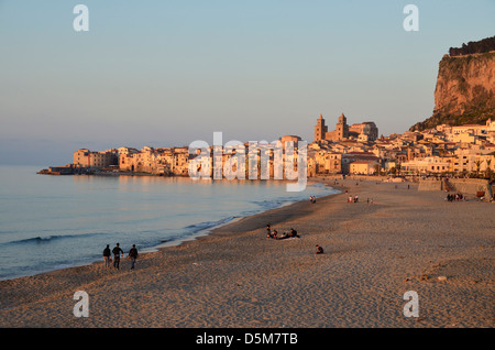 Beachgoers in the historic town of Cefalu on the coast of Sicily, Italy ...
