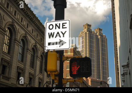 A one way sign and a traffic light in Ney York City, NYC Stock Photo ...