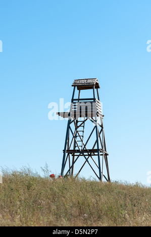 Wooden lookout tower for hunting in the woods and on meadow Stock Photo ...