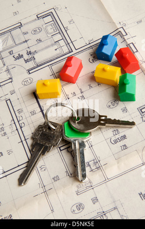 Colorful house models and keys arranged on a blueprint of a house ...