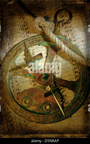 Navigational instrument resting on a table covered with nautical charts ...