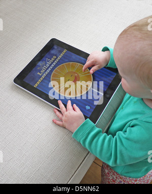 Little girl is using Apple iPad to draw and entertain herself at home ...