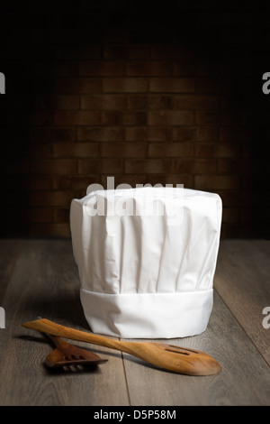 Chef hat and wooden spoons on wooden table Stock Photo - Alamy