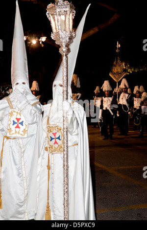 Nazarene dressed in white tunics, hoods and masks during the Semana ...