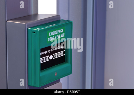 A green emergency door release button isolated on a white background ...