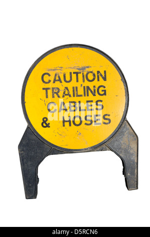 A sign warns of trailing cables and hoses before an area of road works ...