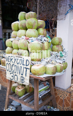 Coconuts for sale on a market stall Stock Photo - Alamy