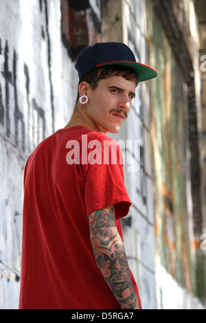 A young Rapper walking down a urban street Stock Photo - Alamy