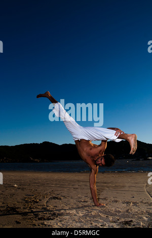 man doing "capoeira" martial arts at the beach Stock Photo - Alamy