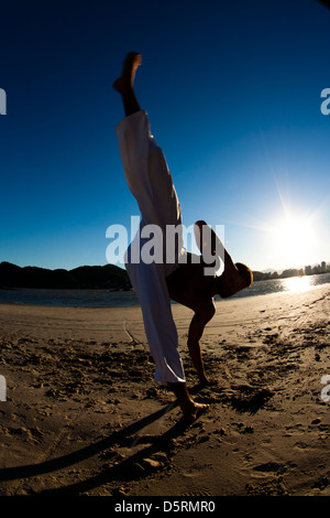 man doing "capoeira" martial arts at the beach Stock Photo - Alamy