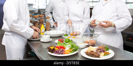 A senior chef giving cooking lesson to young chefs Stock Photo - Alamy