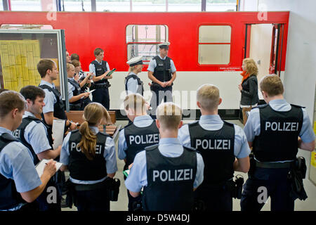 Police officer trainees practice scenes from the daily life of a police ...