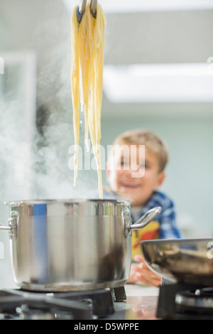 young boy cooking spaghetti Stock Photo - Alamy