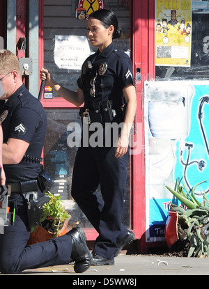 Lucy Liu dresses as a police officer on the set of the television show ...