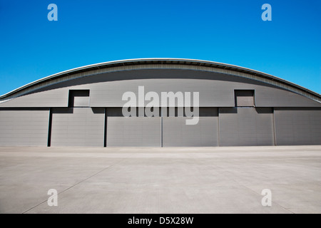 Curved roof of warehouse and blue sky Stock Photo - Alamy