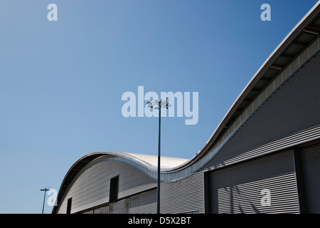 Curved roof of warehouse and blue sky Stock Photo - Alamy